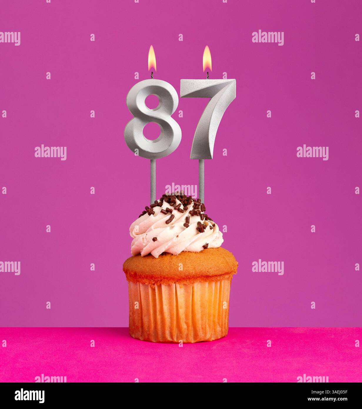 Birthday candle number 87 with cupcake on violet background Stock Photo ...