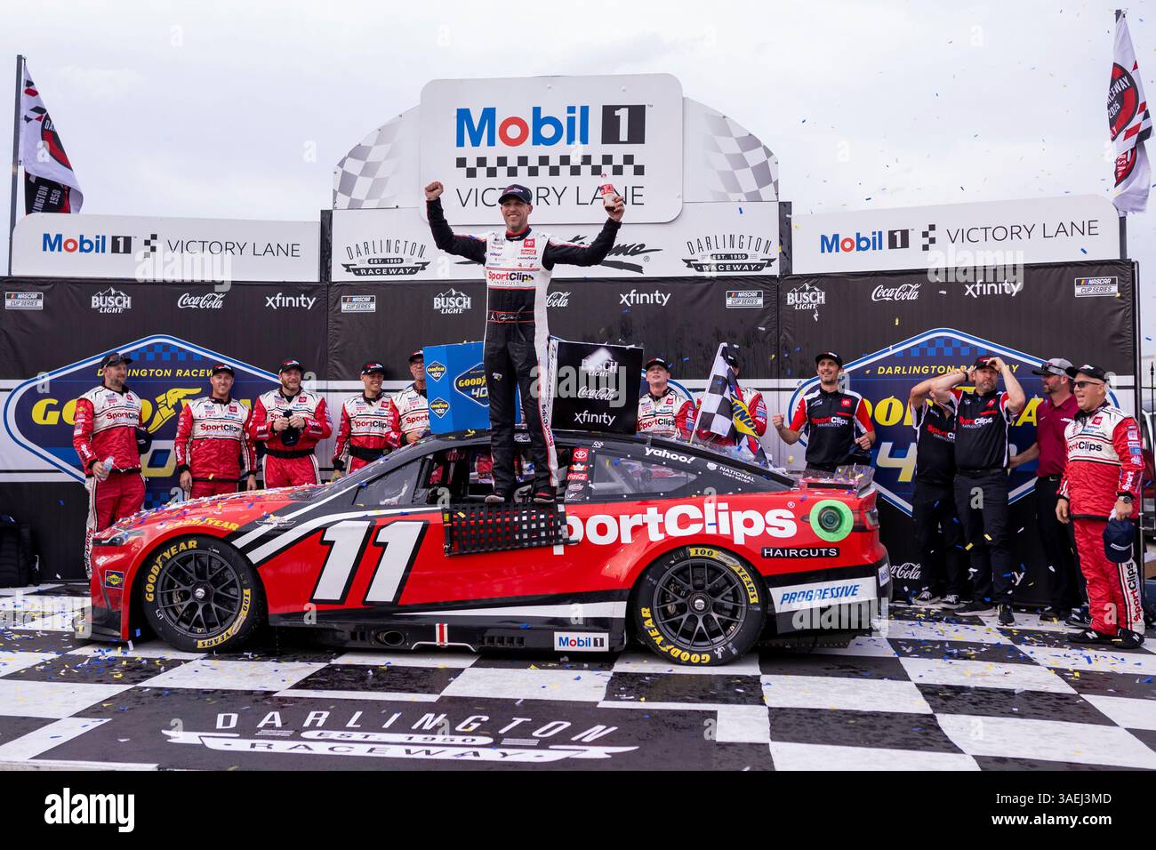 Denny Hamlin, front, celebrates on Victory Lane after winning a NASCAR ...