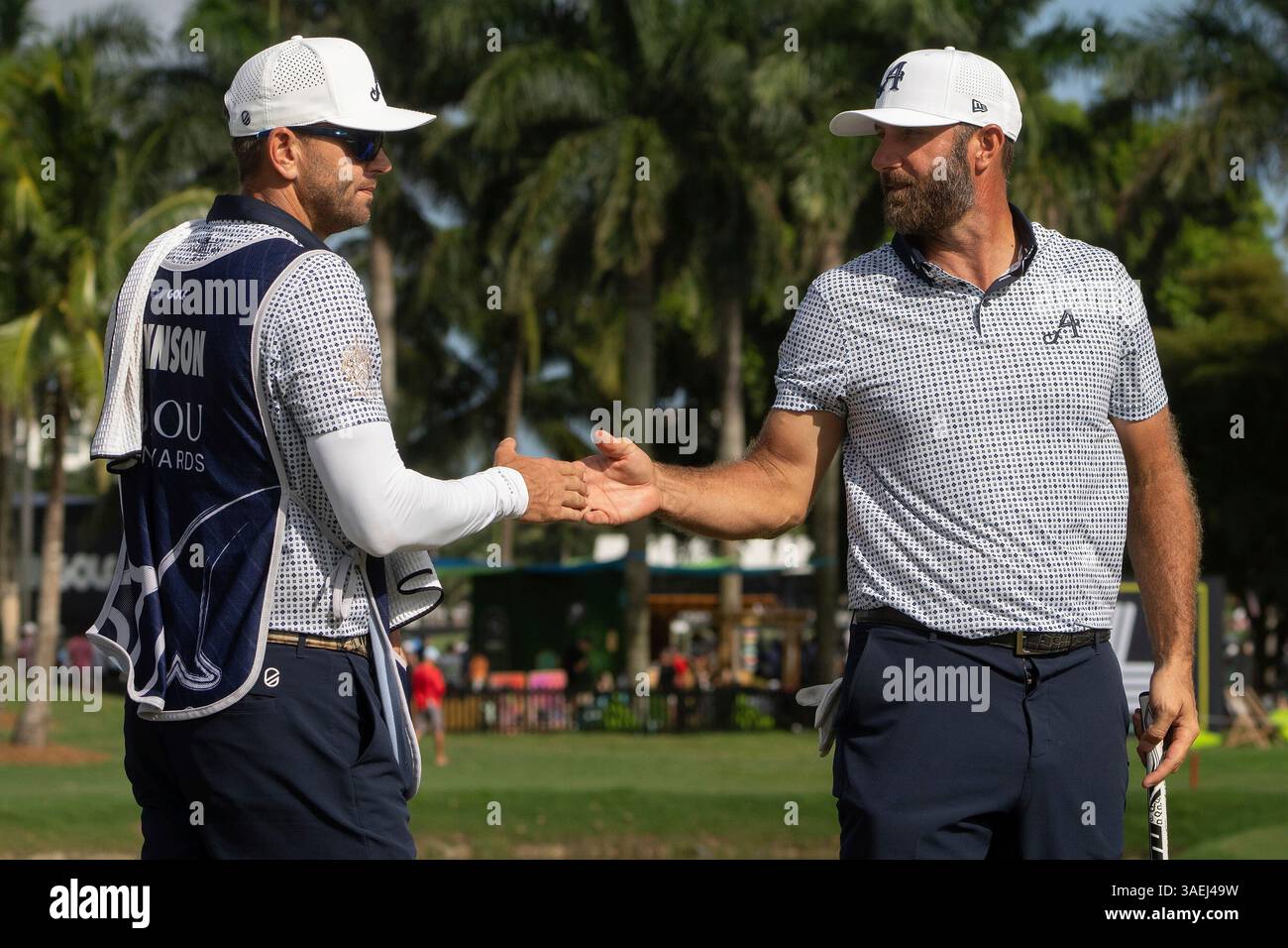 Captain Dustin Johnson of 4Aces GC and caddie, Austin Johnson, are seen ...