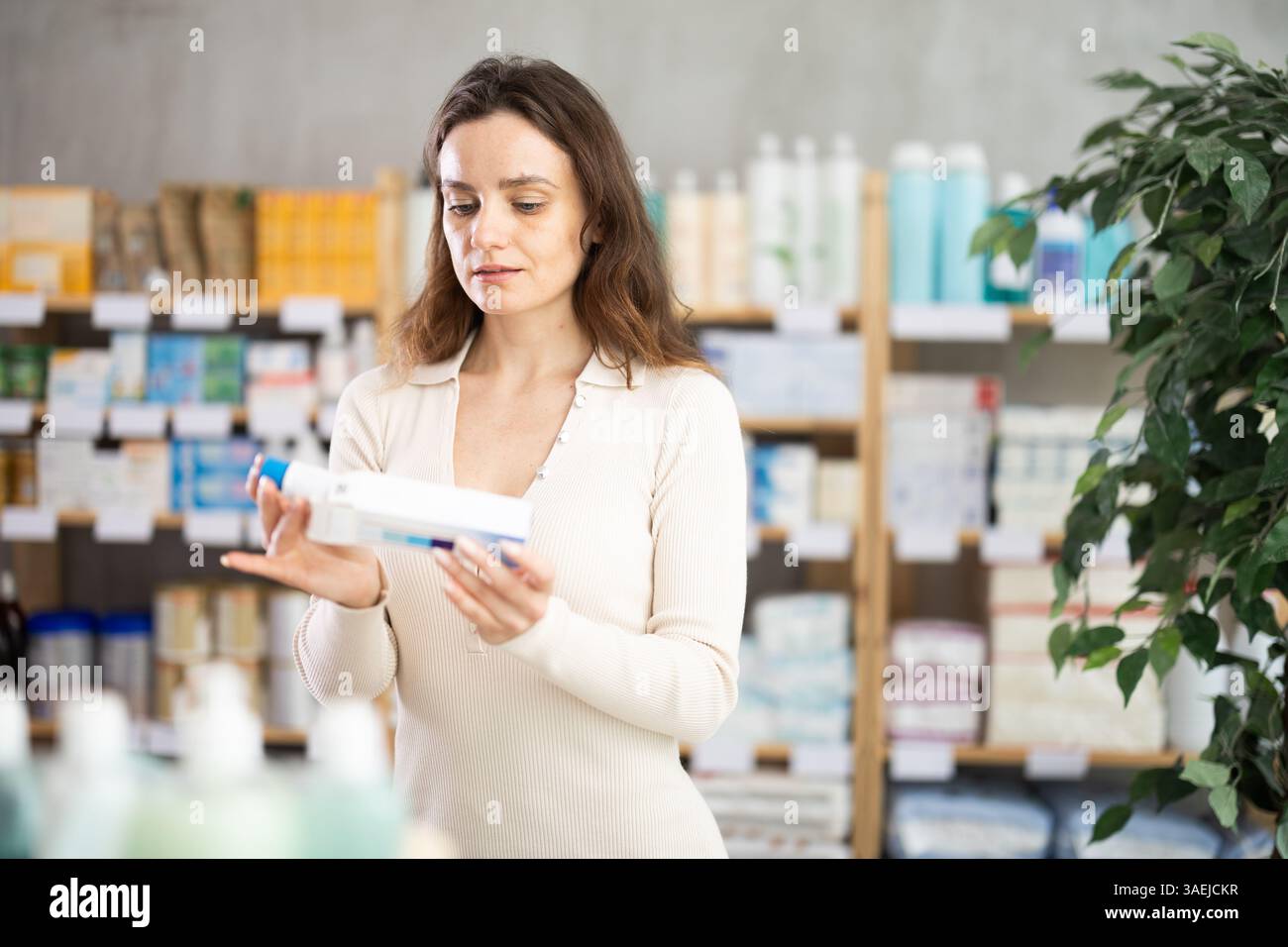 In drug store, woman examine ointment for bruises Stock Photo - Alamy
