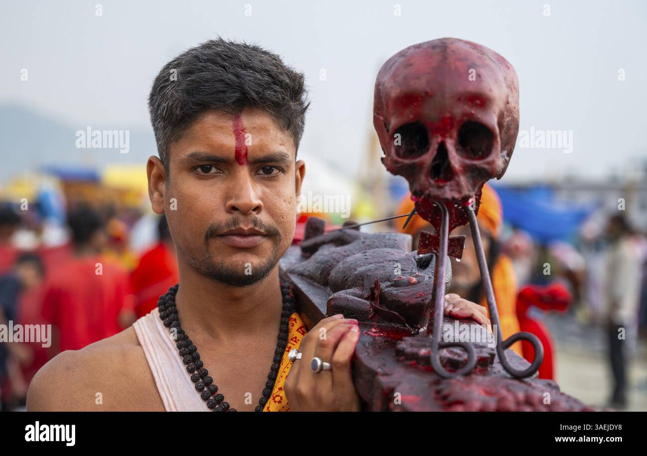 A Hindu priest arrives awith a human skull on the bank of Brahmaputra ...