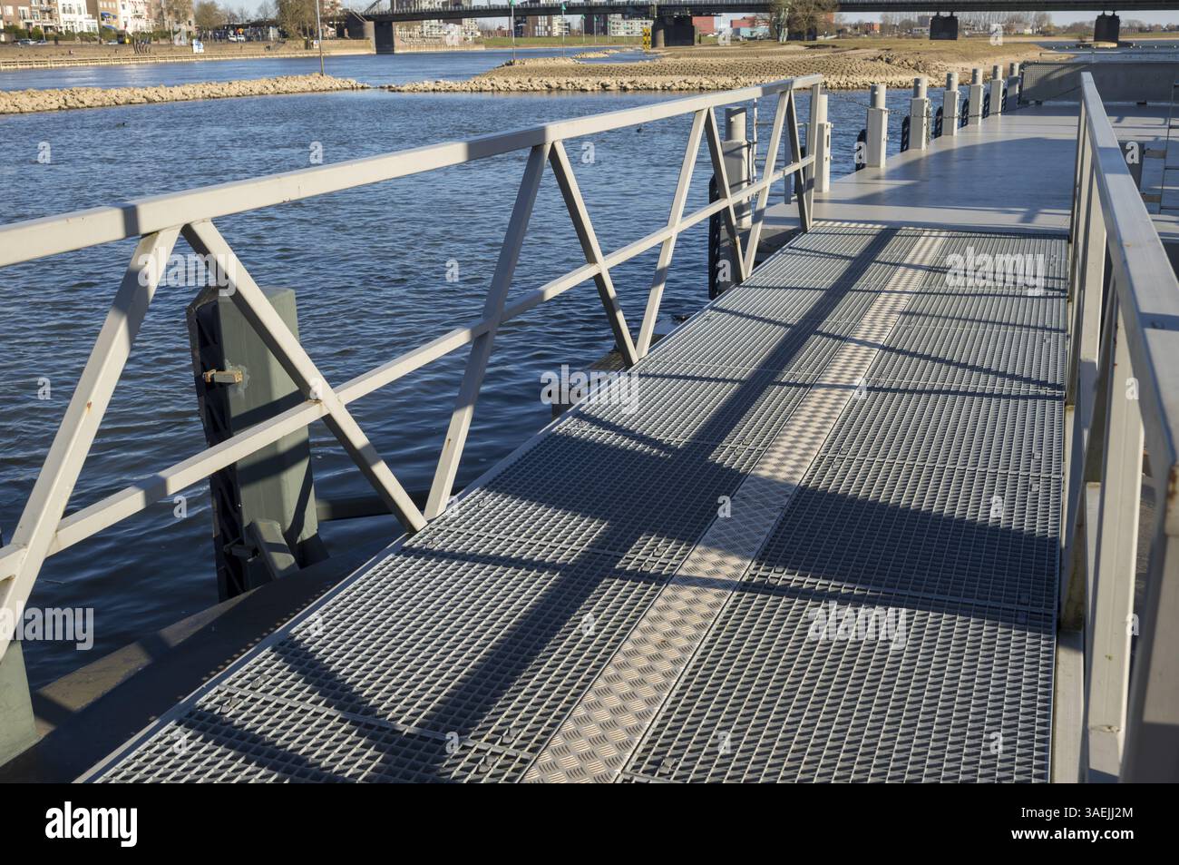 Sunlight casting shadows on the metal grating of a modern dock ...