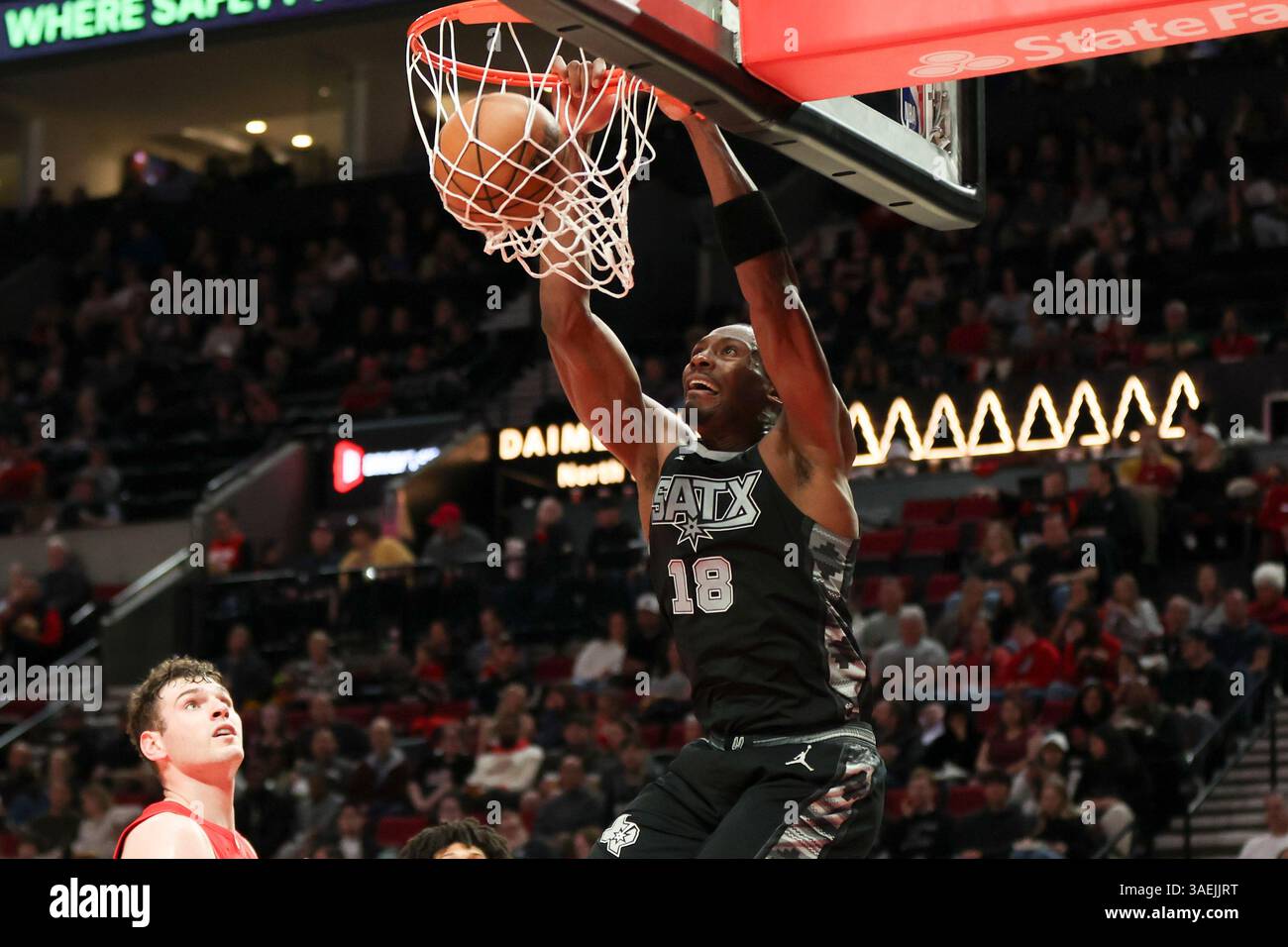 San Antonio Spurs center Bismack Biyombo (18) dunks against the Portland Trail Blazers during ...