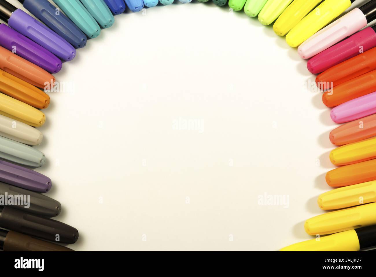 Colored markers placed in a circle on a white background with copy ...