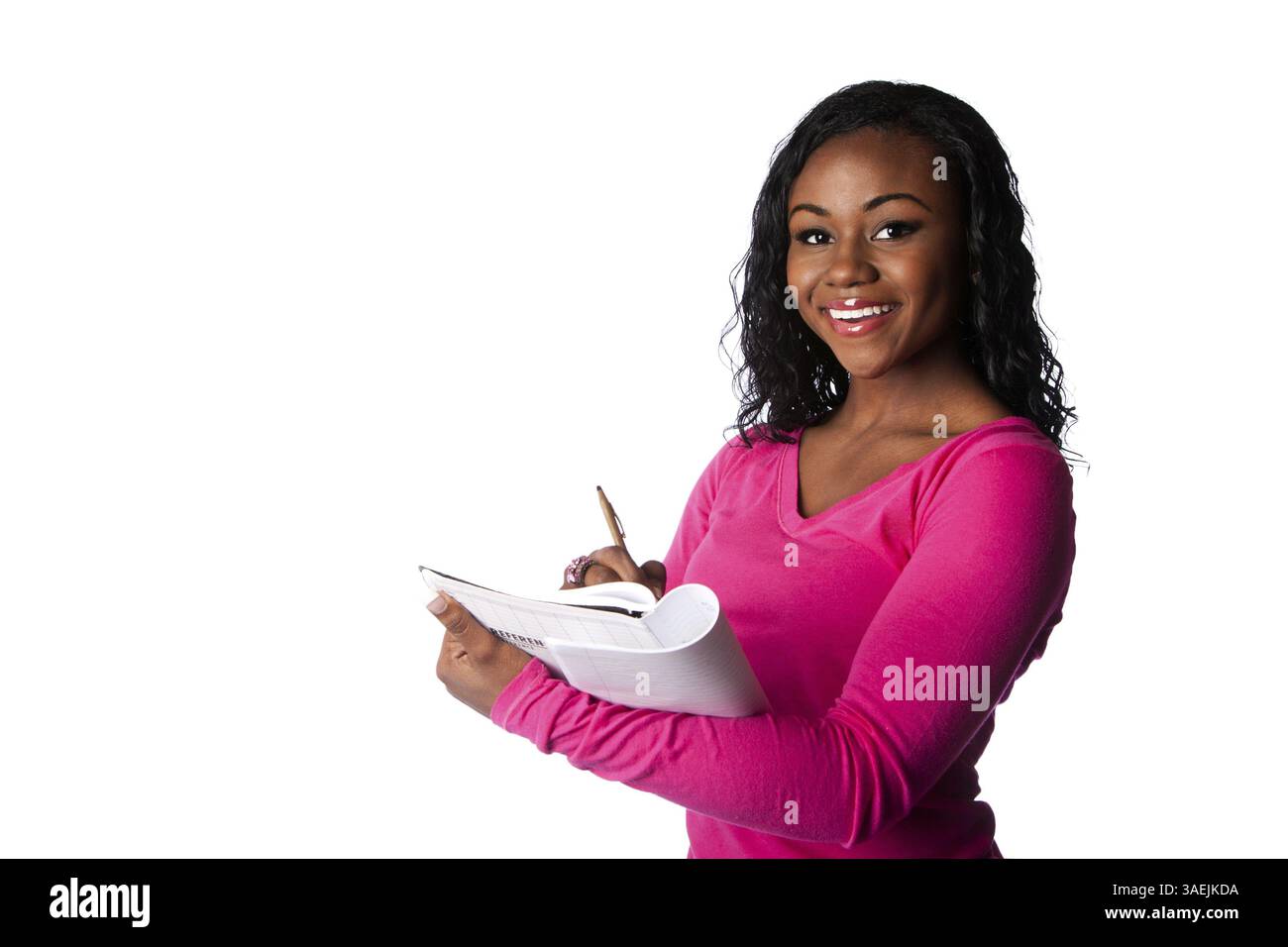 Beautiful happy smart college student smiling and writing in notebook ...