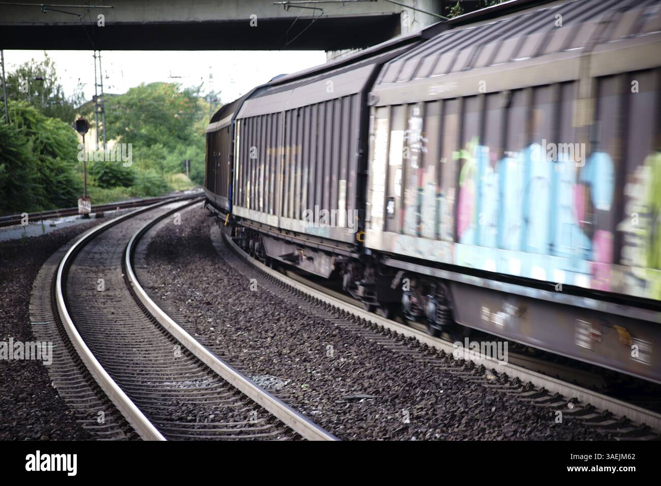 The side view of a goods train travelling into a curve Stock Photo - Alamy