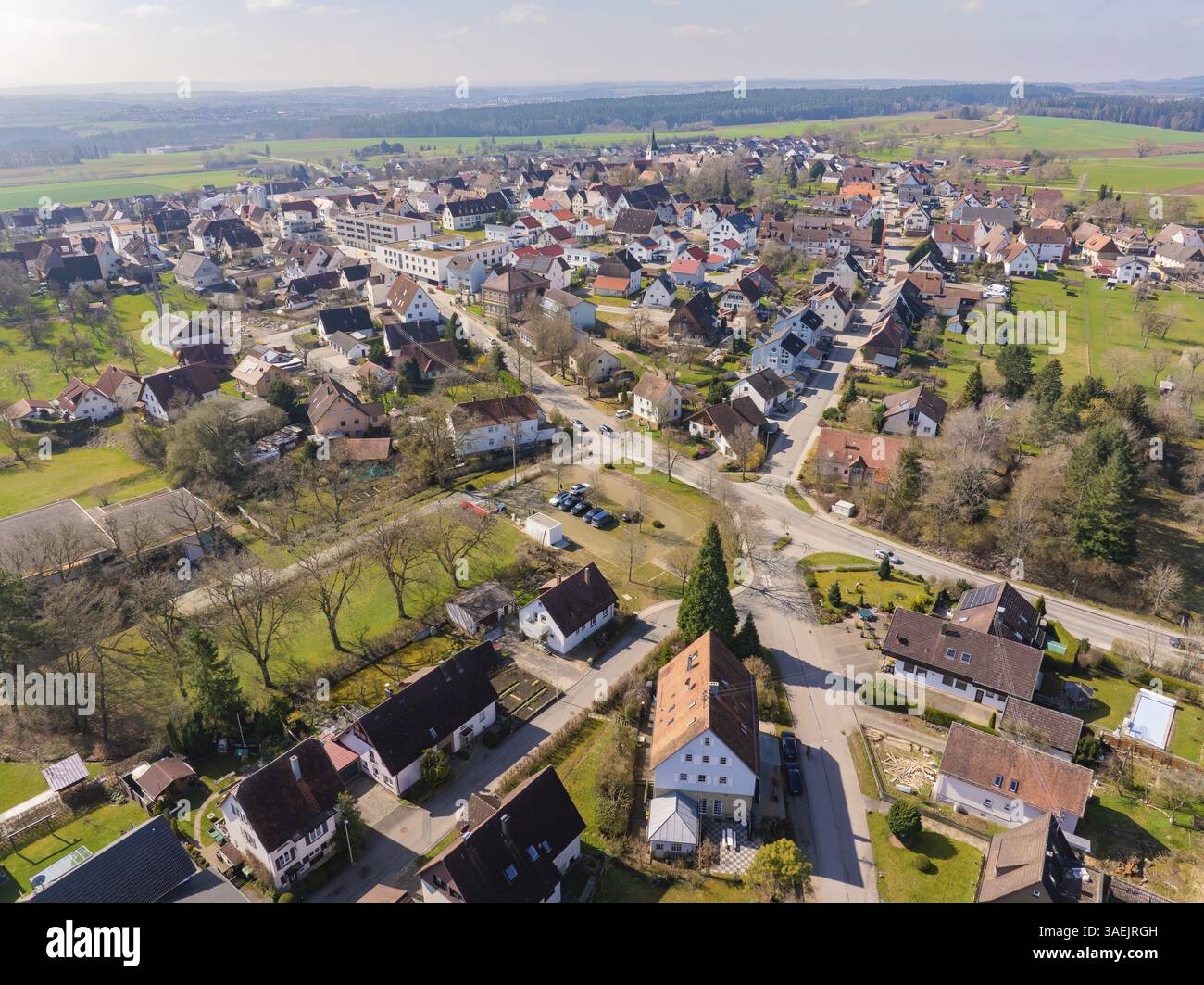 Densely built-up village with various buildings and neighbouring green ...