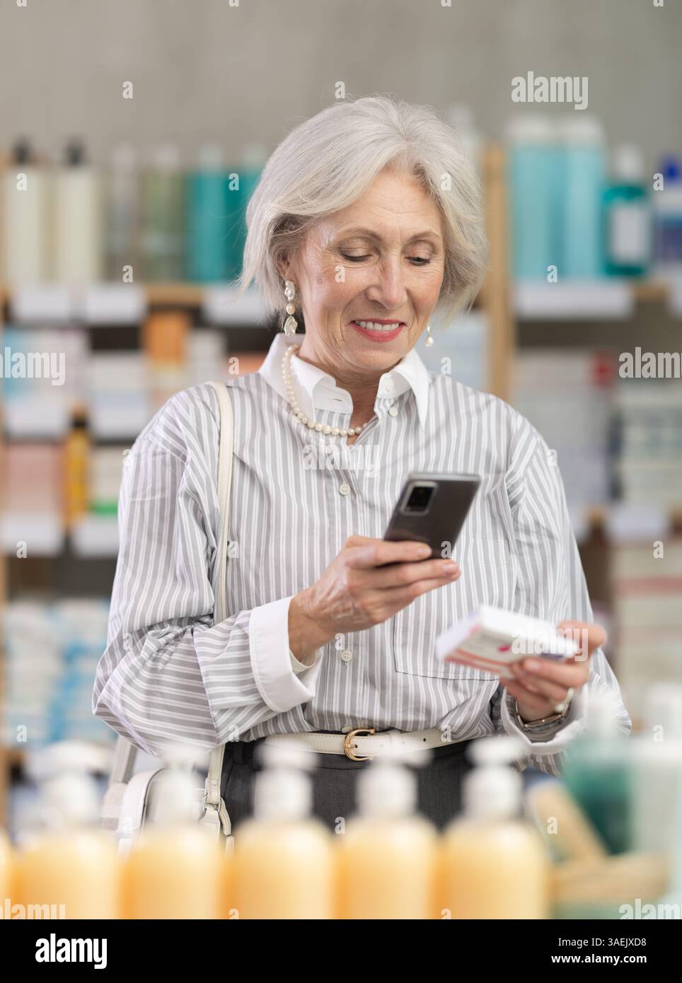 Elderly woman scanning qr code of paracetamol Stock Photo - Alamy