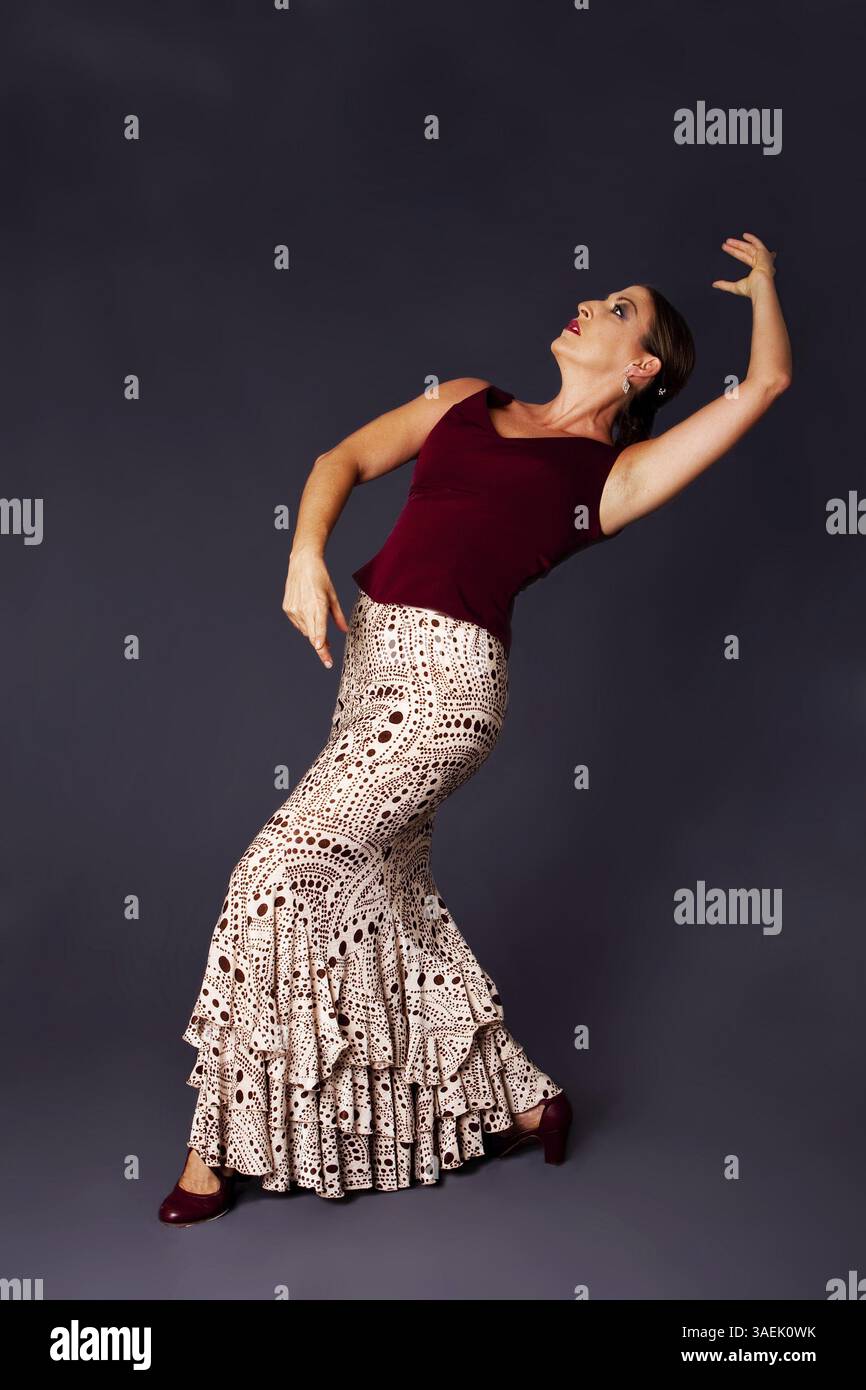 Beautiful female Flamenco dancer doing a typical line pose, wearing ...
