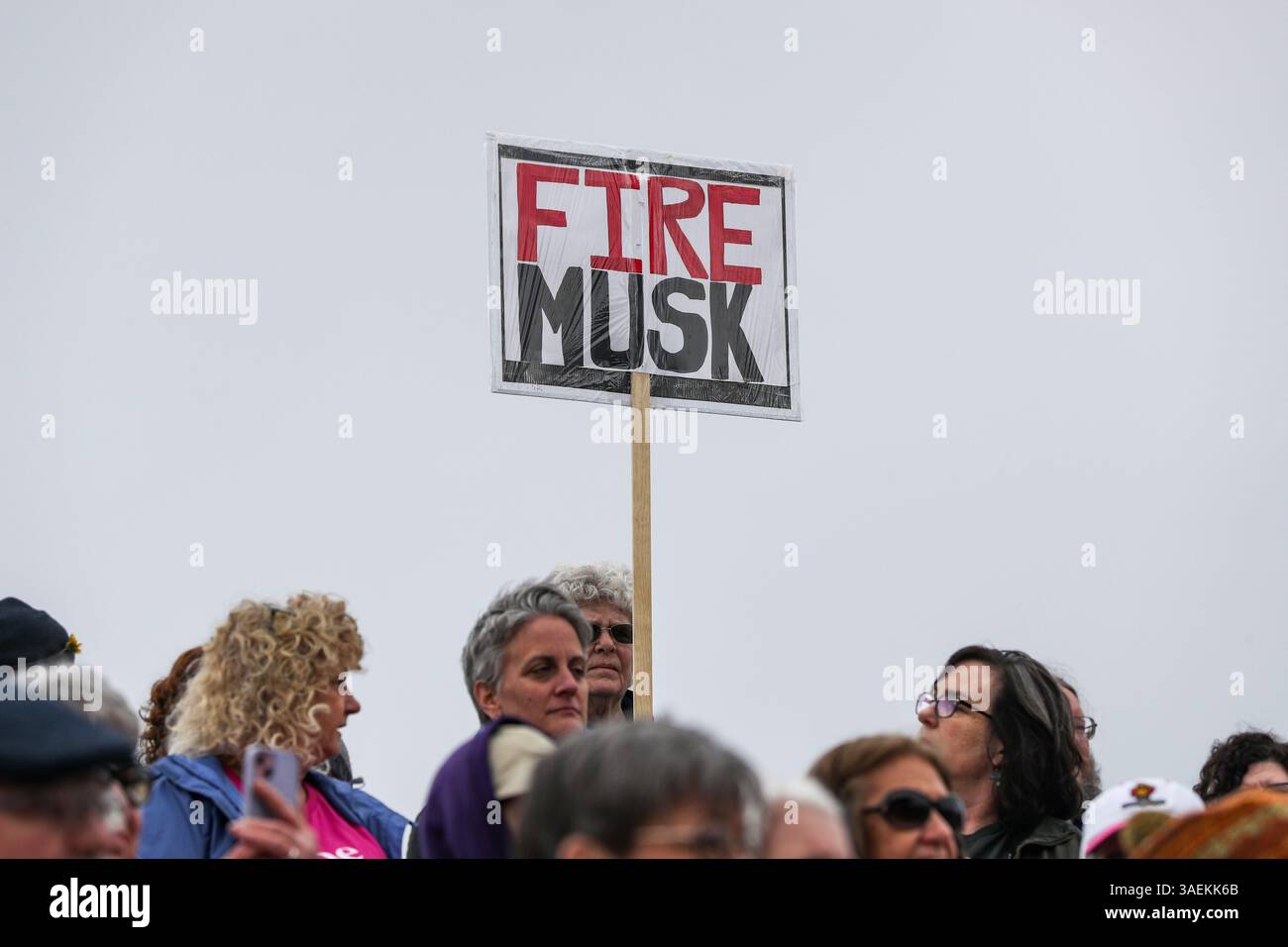 A demonstrator holds a "fire Musk" sign during the "Hands Off!" protest ...