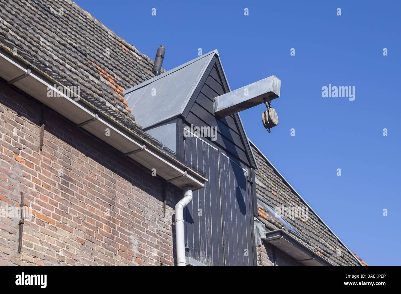 Traditional wooden pulley system attached to the exterior of a brick ...