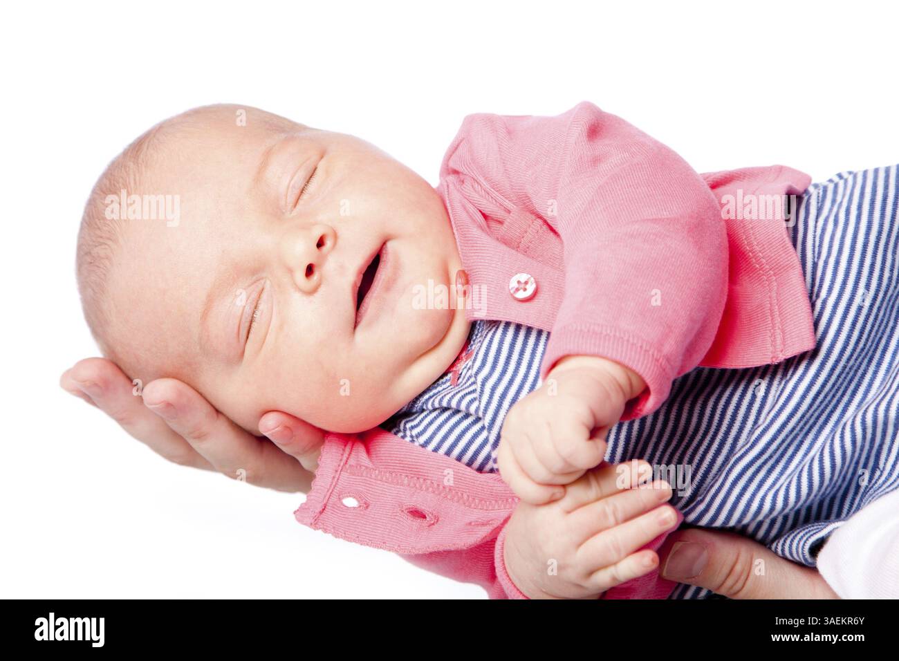 Happy cute baby girl laying in hand asleep with eyes clossed, on white ...