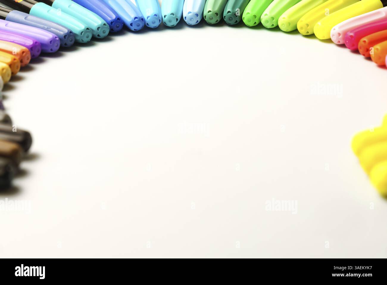 Colored markers placed in a circle on a white background with copy ...