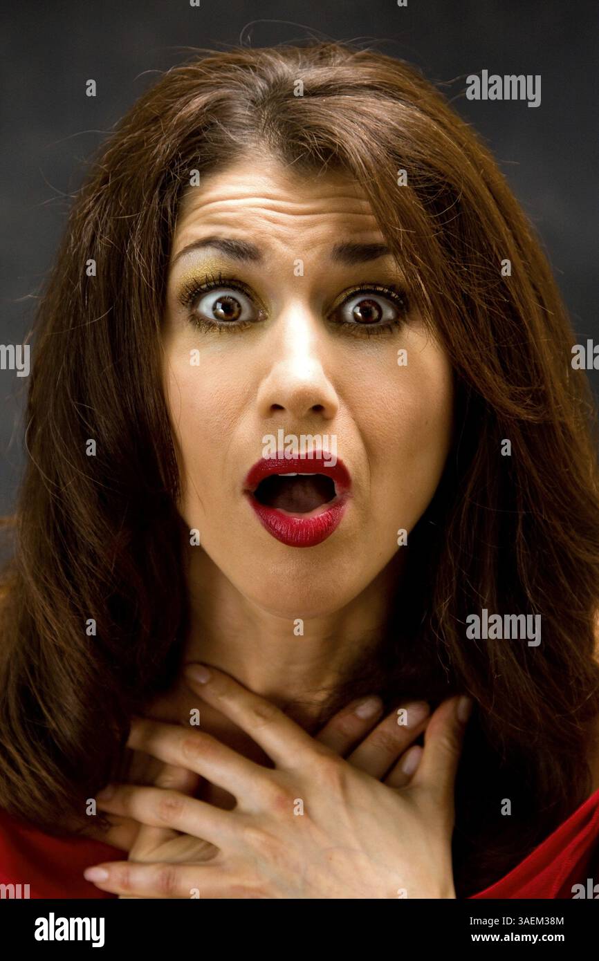 Beautiful woman with shocked expression dressed and mouth open and ...