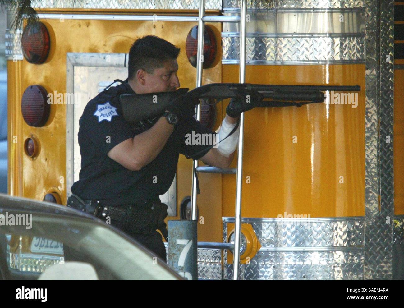 Mar 12, 2004; Fresno, CA, USA; A police officer with a shotgun secures ...