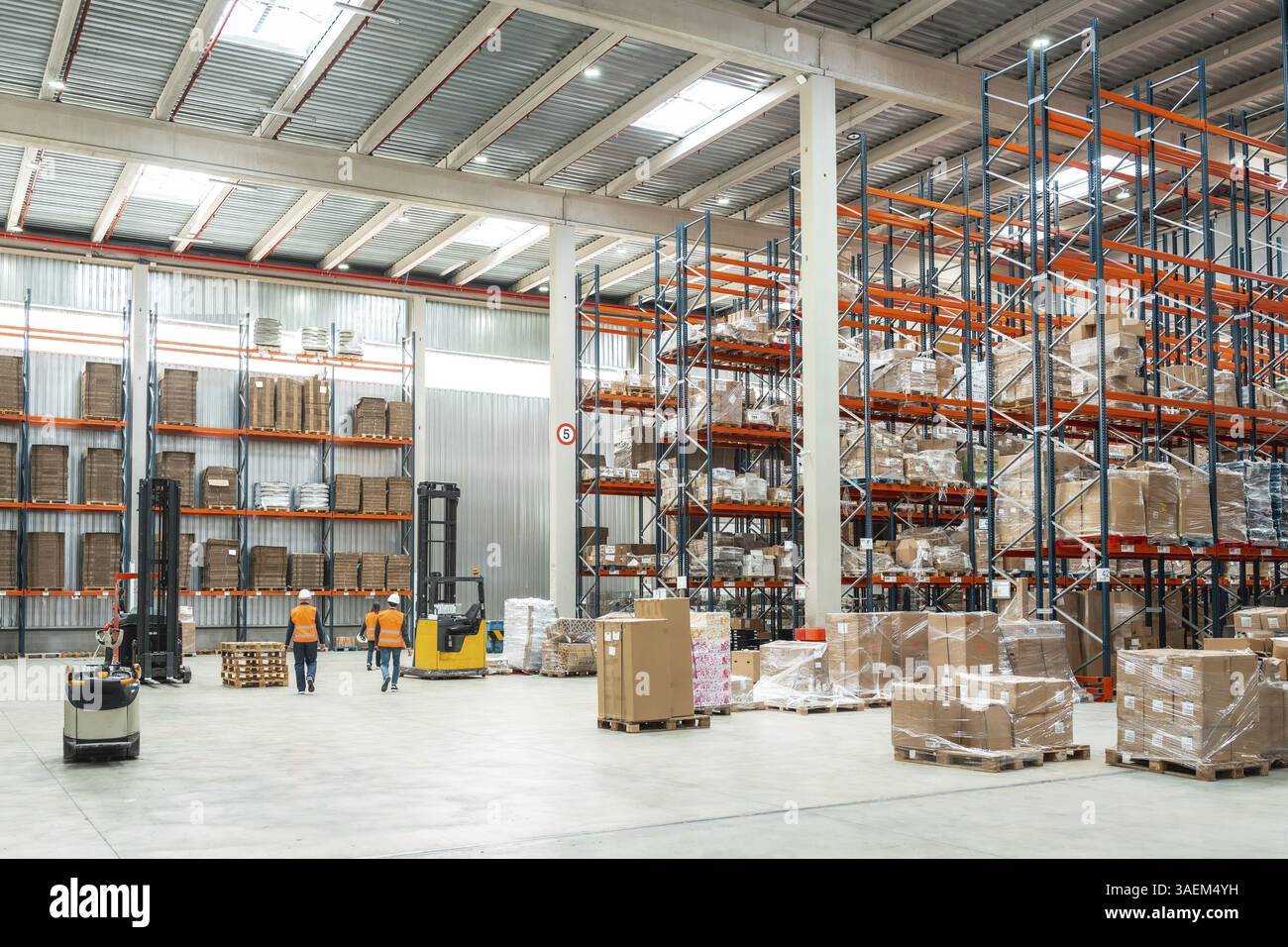 Warehouse workers are managing logistics, operating forklifts, and ...