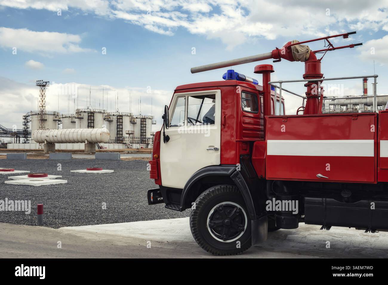 A fire truck with a special foam gun on the cab is on duty at an oil ...