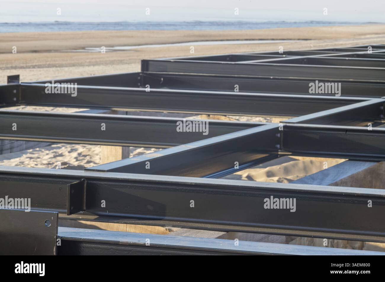 Steel frame foundation being constructed on a sandy beach near the ...