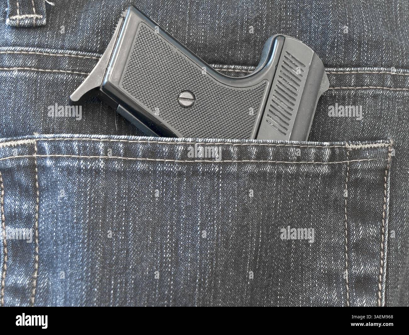 Photo of the jeans pocket with pistol Stock Photo - Alamy