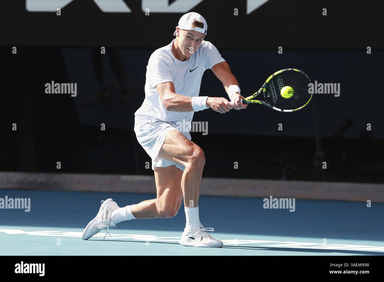 Danish tennis player Holger Rune playing a backhand shot at the Australian Open 2025 tournament ...