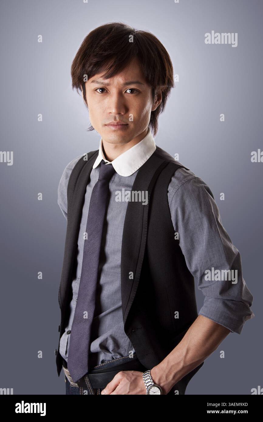 Assertive confident successful casual Asian business man, wearing vest ...
