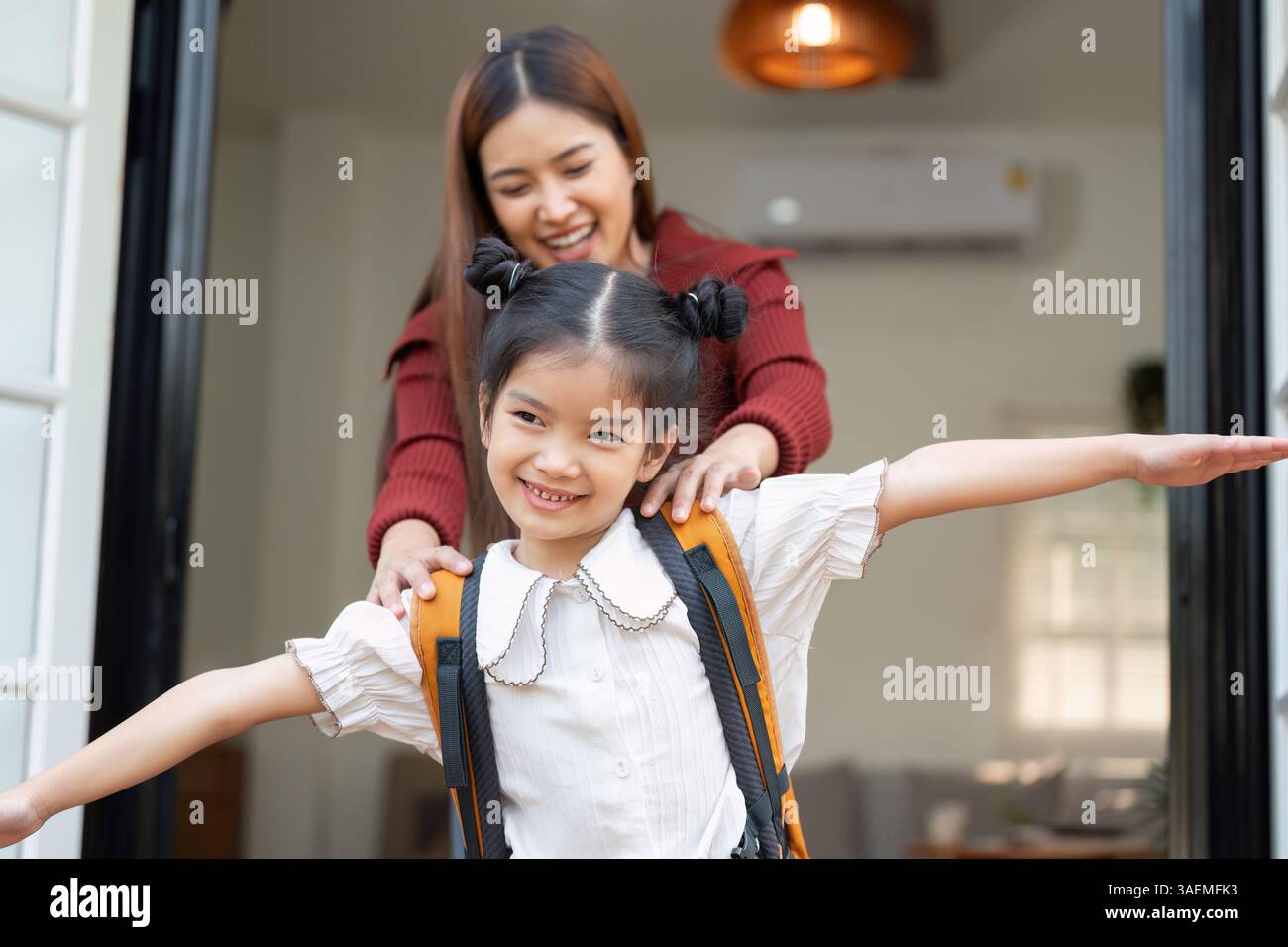 Back to School and Mother-Daughter Bonding. A cheerful girl prepares ...