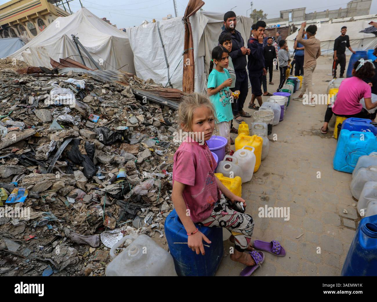 Gaza City. 6th Apr, 2025. Palestinian children wait to fetch water ...