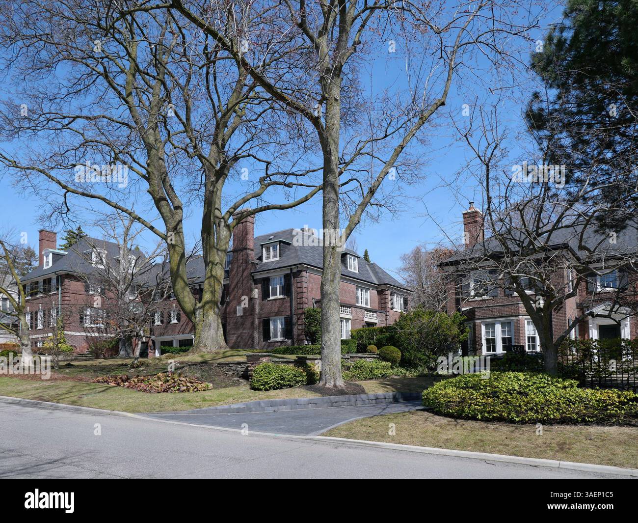 Residential neighborhood with large brick detached houses and mature ...