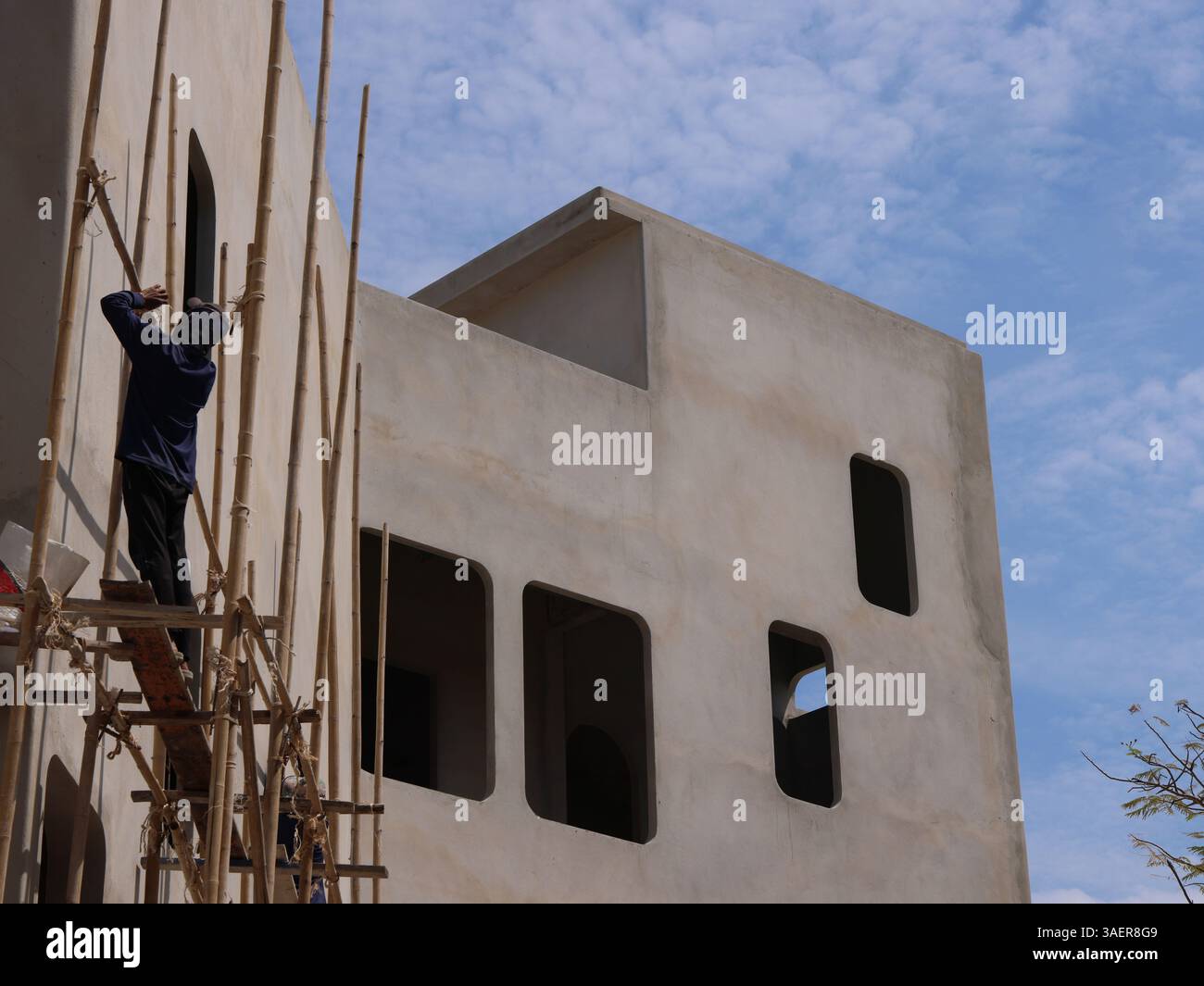 A Construction Worker Engaged on Scaffolding at a Building Site Amidst ...