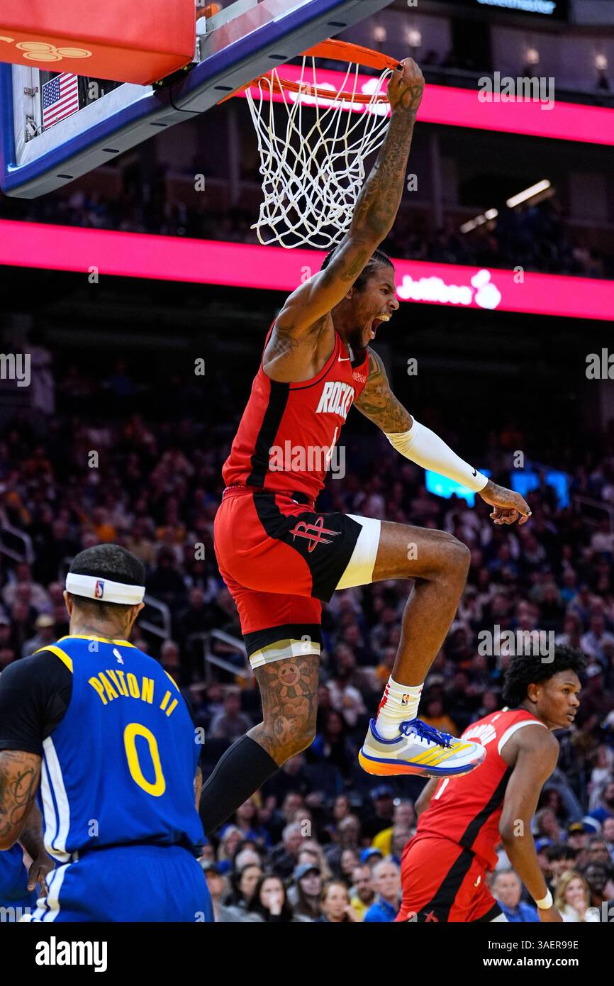 Houston Rockets guard Jalen Green, center, reacts after dunking next to Golden State Warriors ...