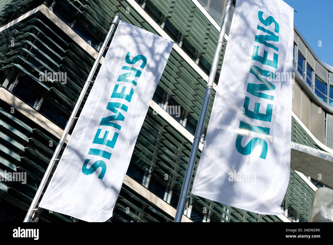 06 April 2025, Bavaria, Munich: The lettering and logo of Siemens AG can be seen on flags in ...
