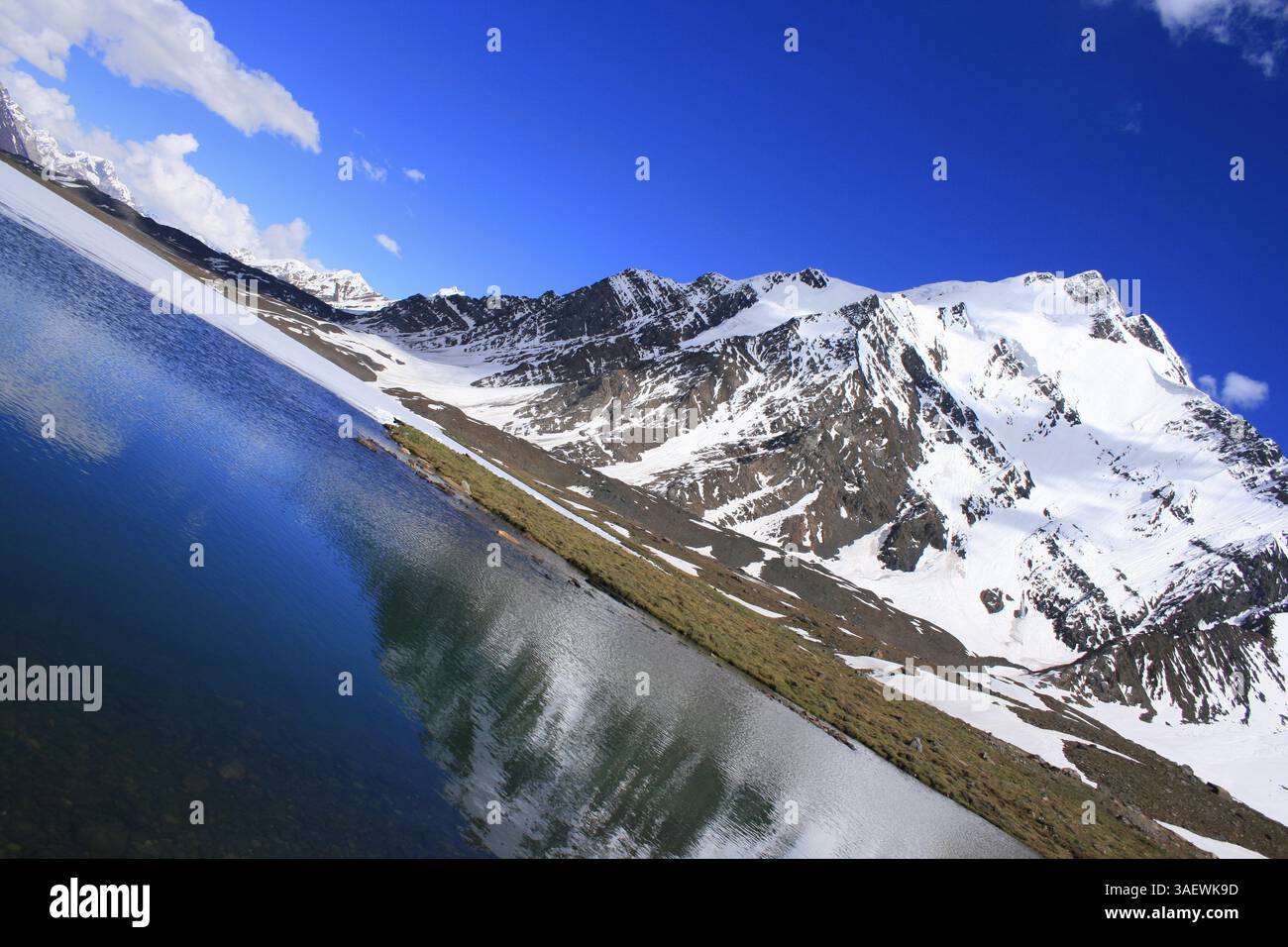 Mountain's reflection in Karomber lake of Baroghil valley Stock Photo ...