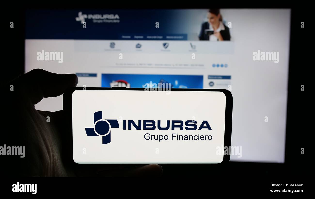 In this photo illustration, a person is holding a cellphone with the ...