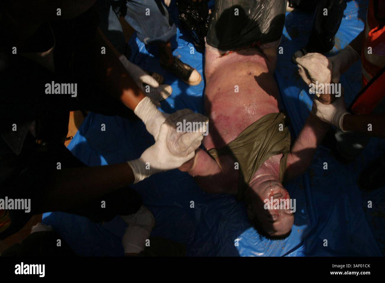 Dec 27, 2004; Phuket Island, THAILAND; Survivors and rescuers are ...