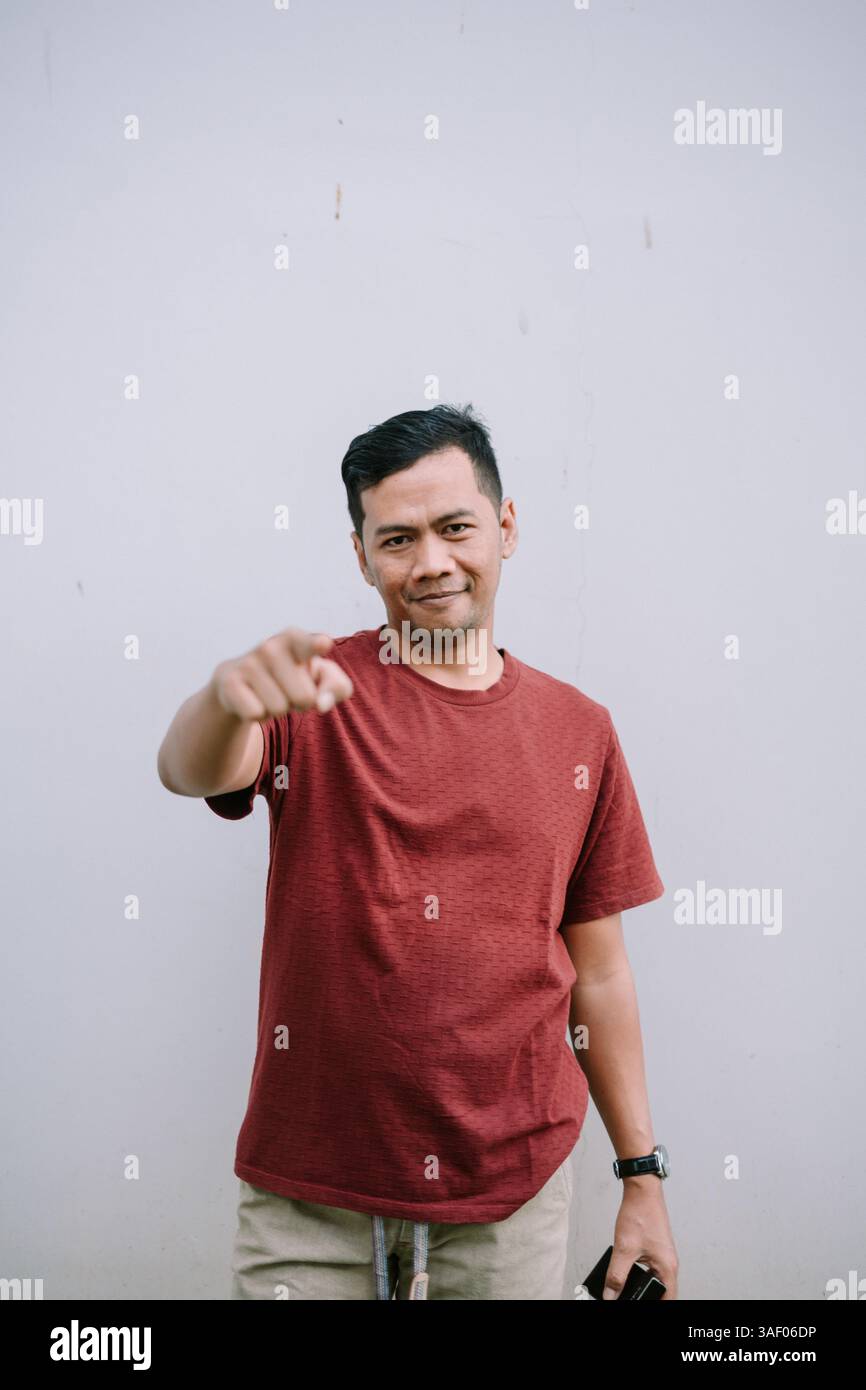 An expressive guy points his index finger toward the camera. This ...