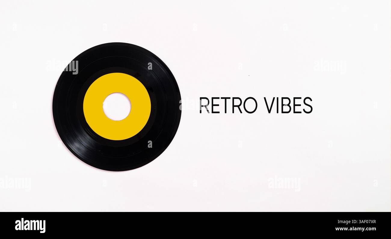 Black vinyl record with yellow label on white background with text ...