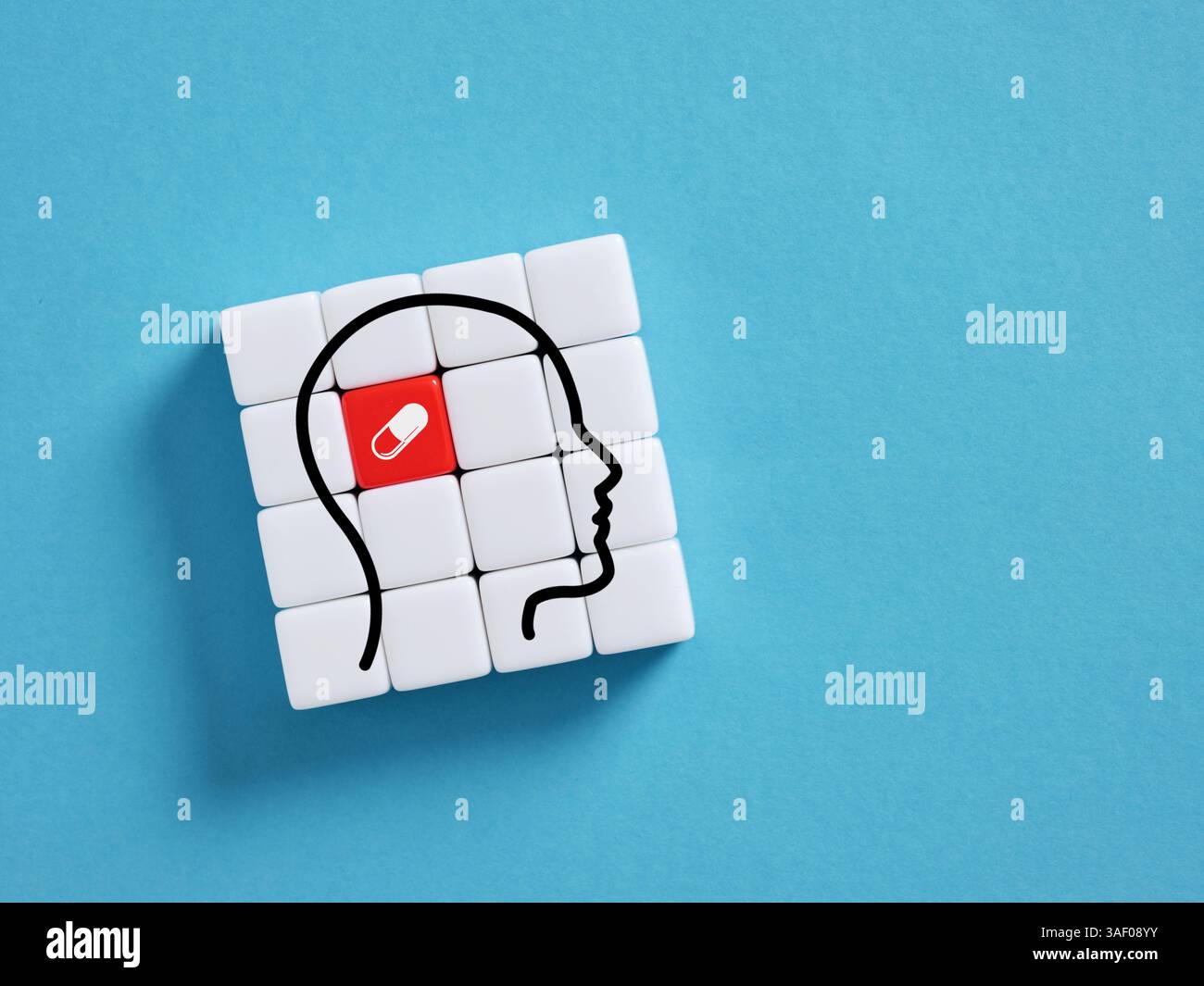 Human head silhouette and red pill inside mind on blue background ...