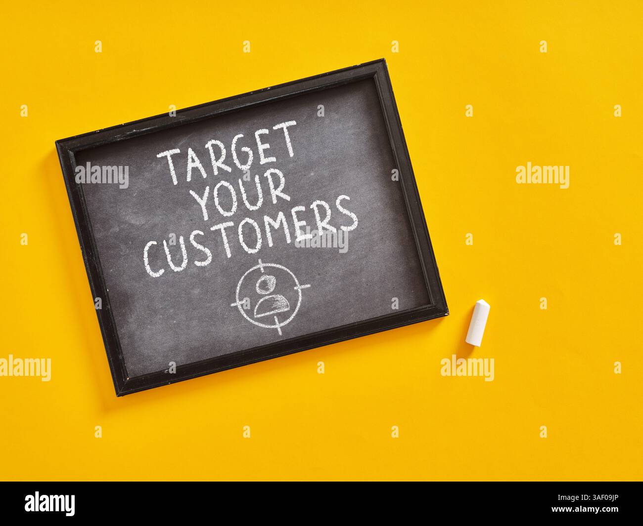 Blackboard displaying target your customers message with customer icon ...