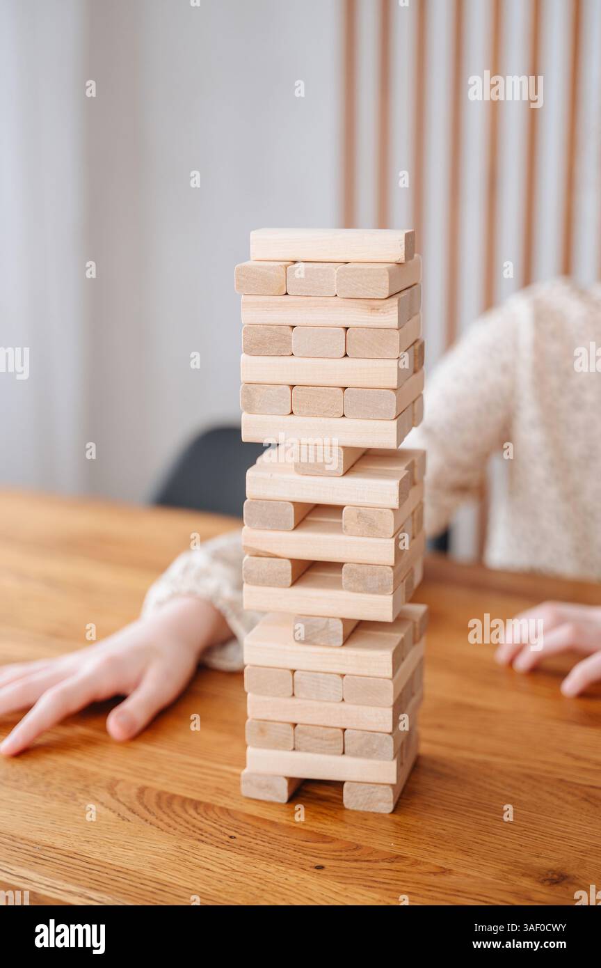 children playing educational board game at home in kitchen, girl ...