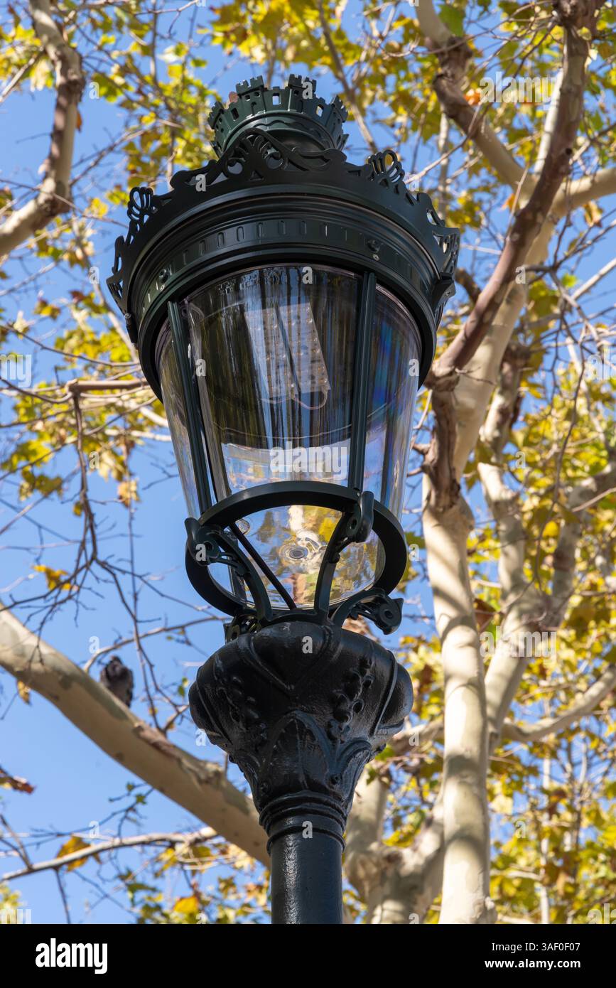 A vintage street lamp beautifully stands against a clear blue sky ...