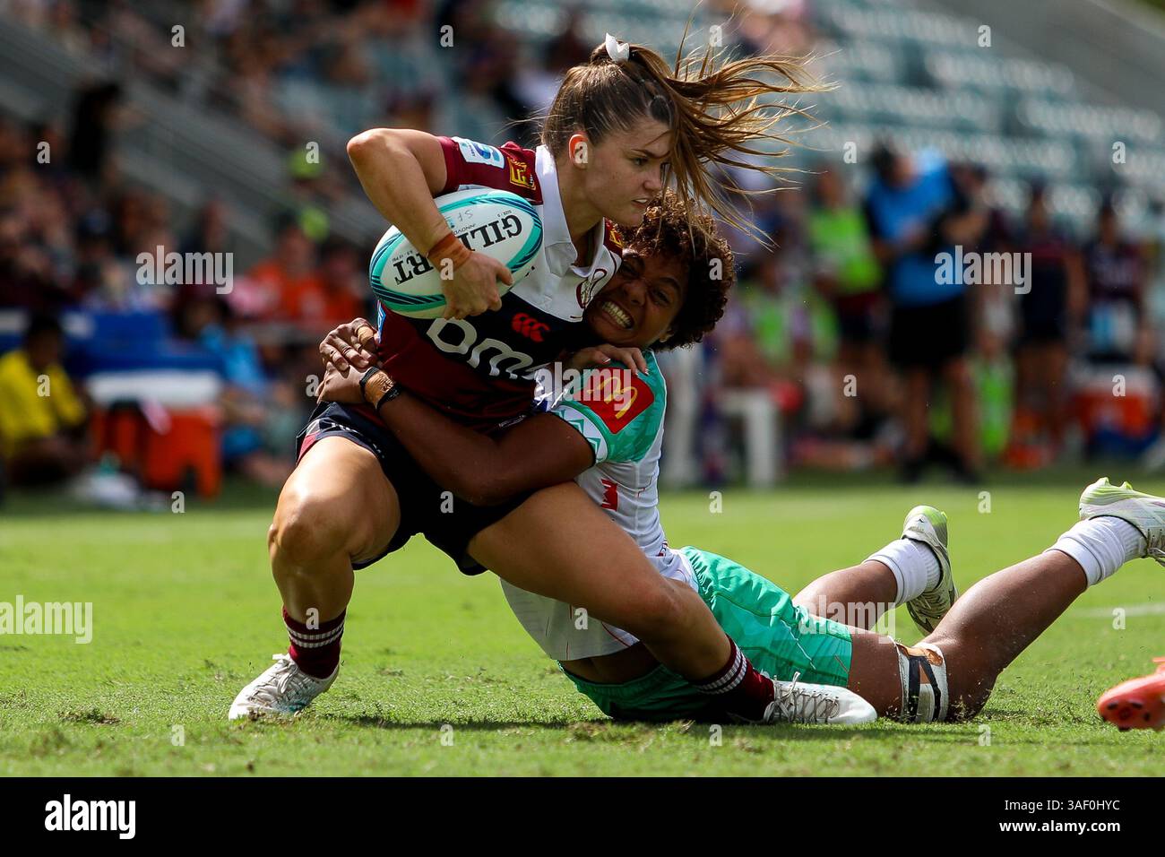 Queensland Reds winger, Caitlin Urwin being tackled by a Fijian Drua ...