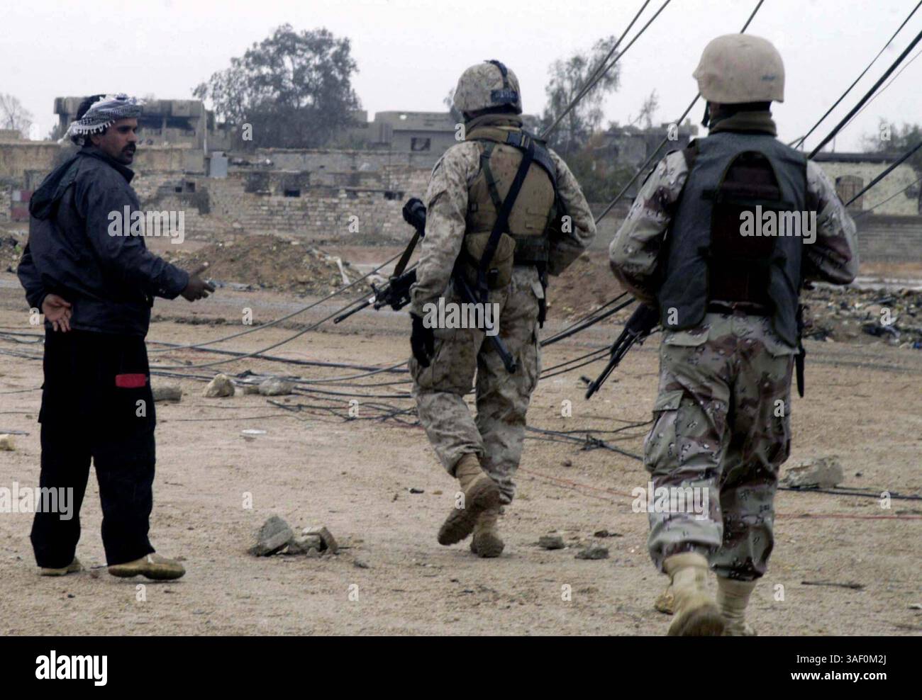Jan 24, 2005; Fallujah, Iraq; An Iraqi man leads a joint patrol of ...