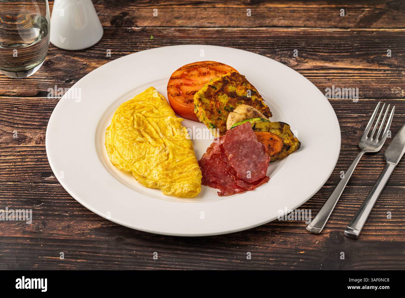 Rustic breakfast plate with fried eggs, grilled vegetables, and turkey ...