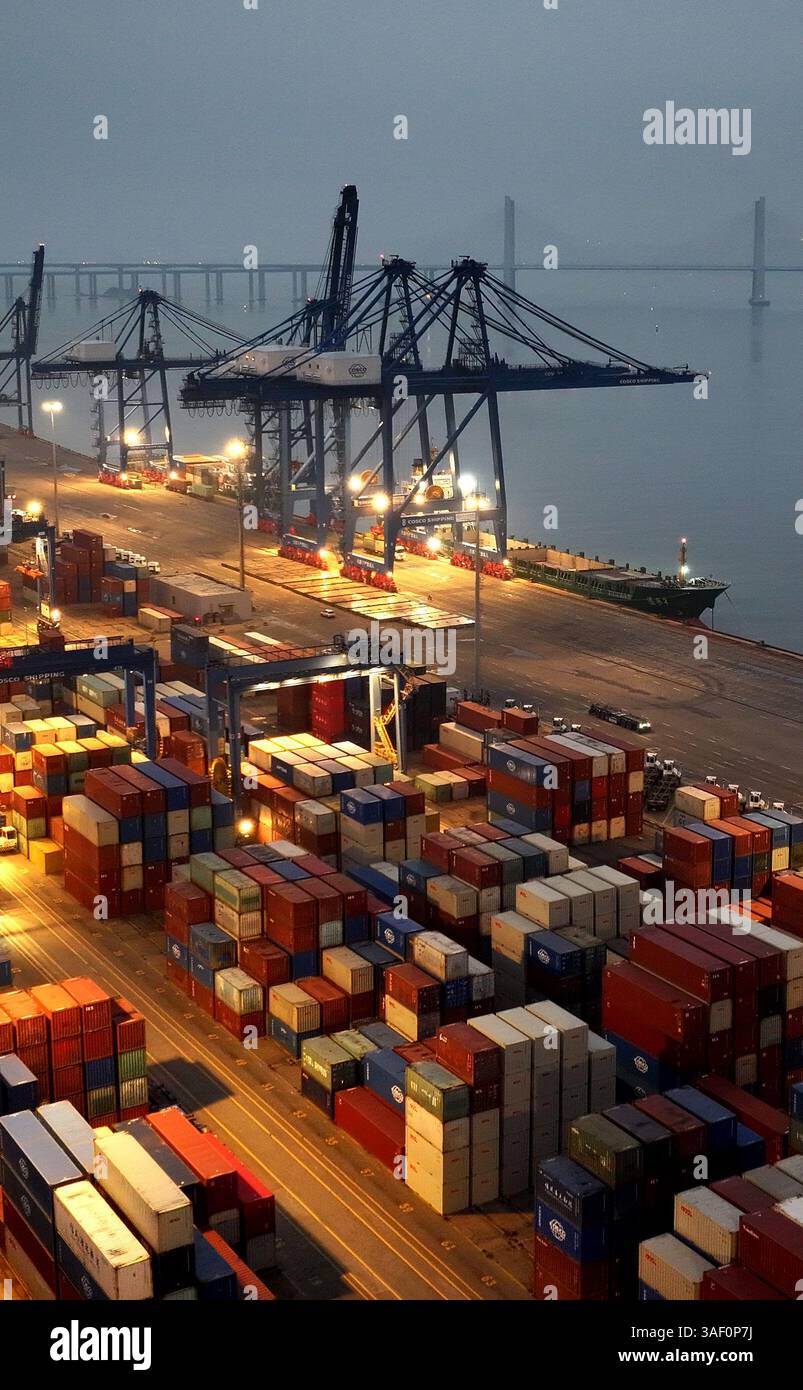 Cargo ships load and unload containers in an orderly manner at the ...