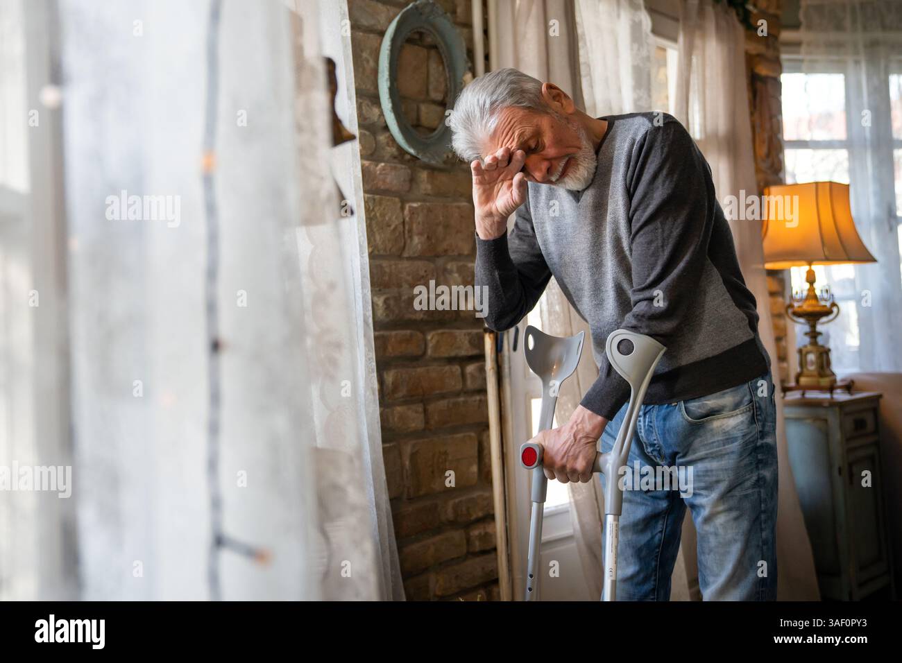 Old man with crutch feeling disappointed, lost in sad thoughts alone at ...
