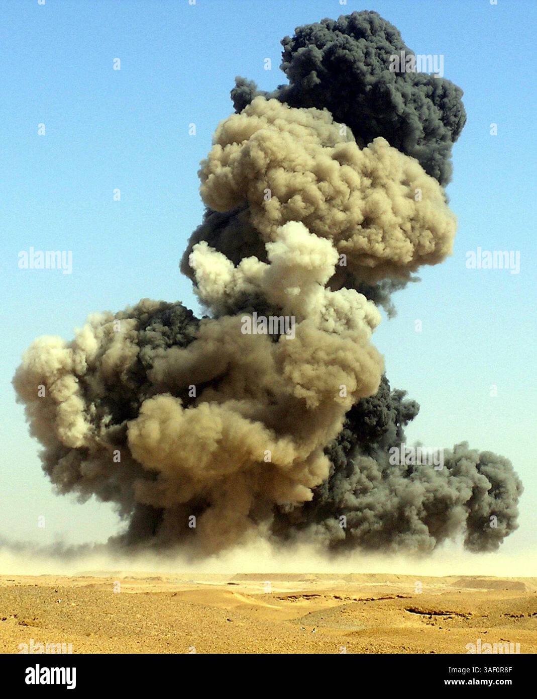 Feb 21, 2005; Ammo Supply Point Dulab, Iraq; A ploom of smoke erutps ...
