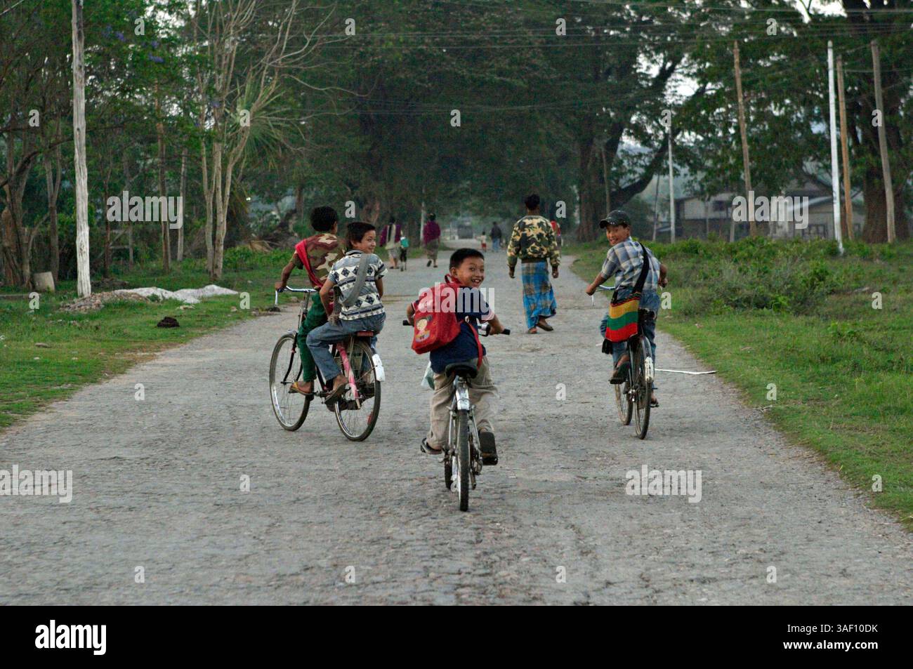 Apr 19, 2004; Hsipaw, Shan, BURMA (MYANMAR); Children ride their bikes ...