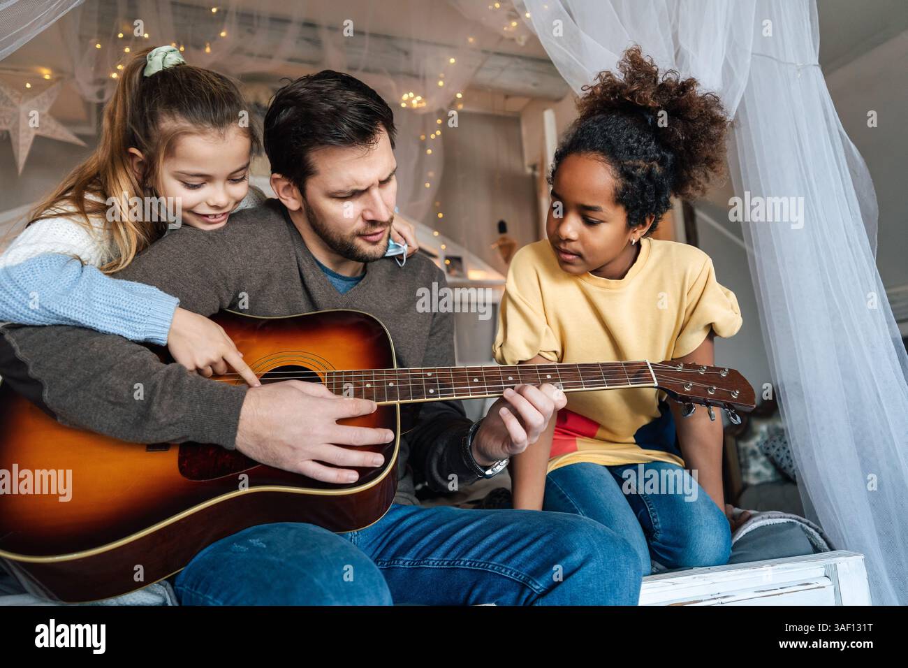 Happy single father teaching his multiethnic, diverse daughters ...