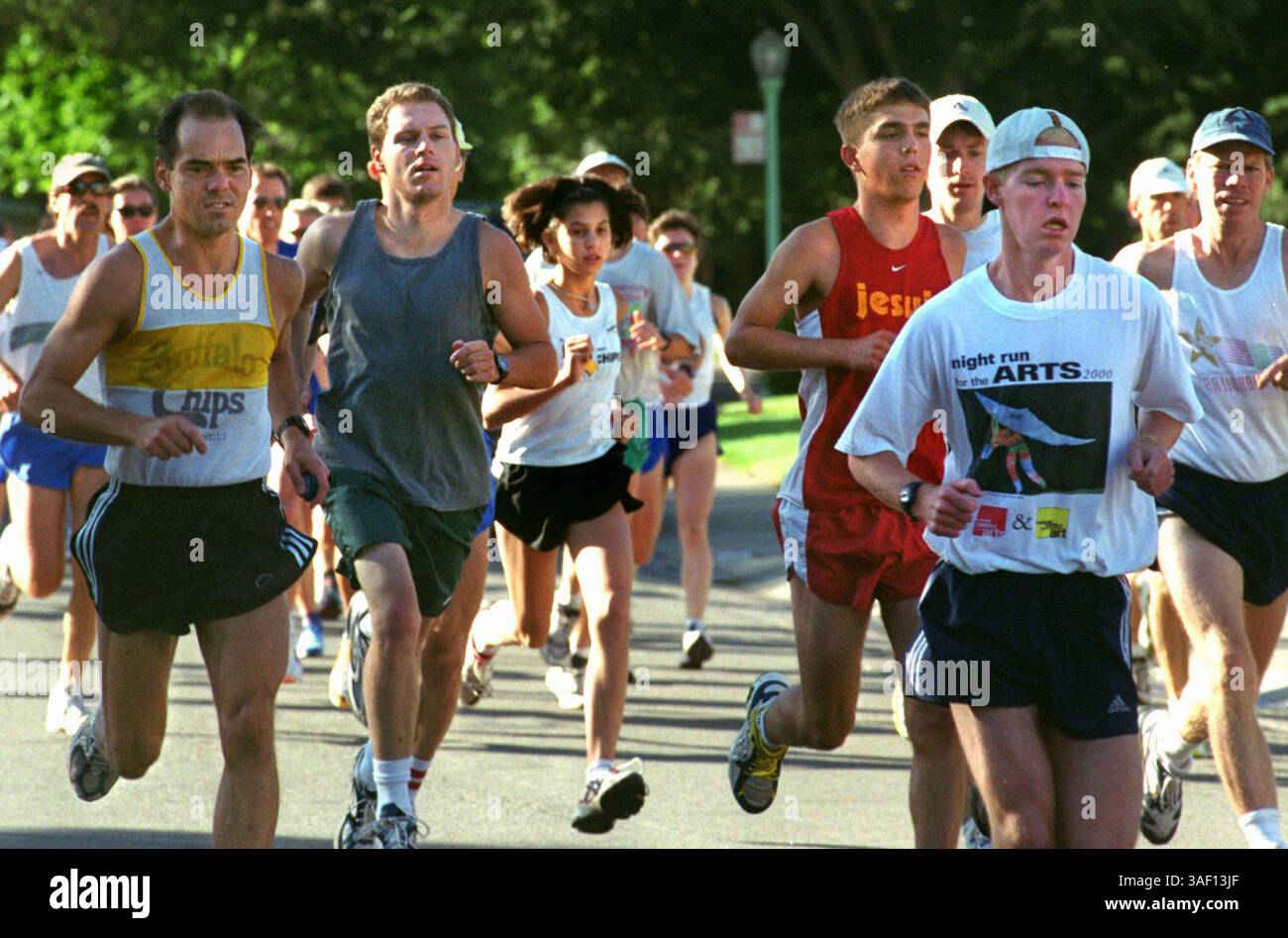 Runners participate in a 5-mile fun run through River Park organized by ...