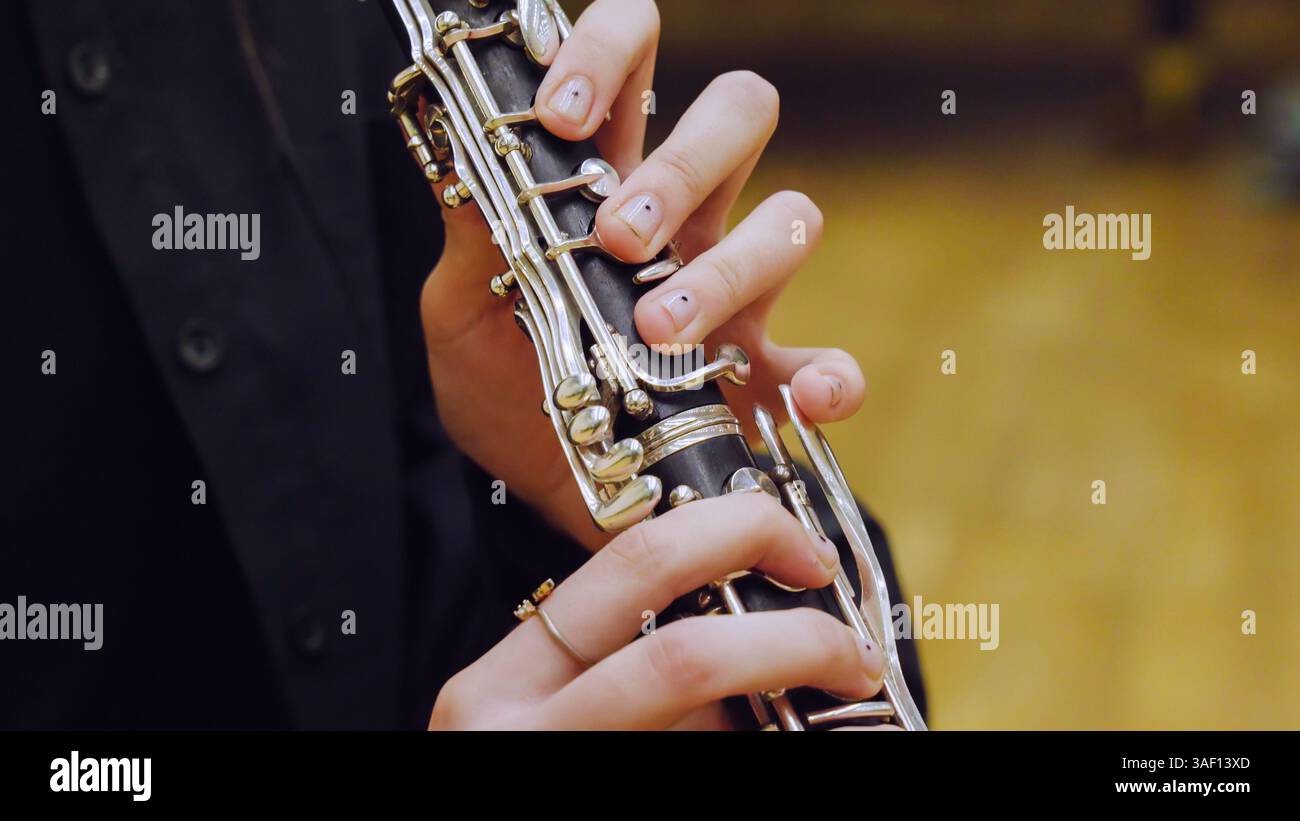 Musician playing clarinet during classical music concert Stock Photo ...